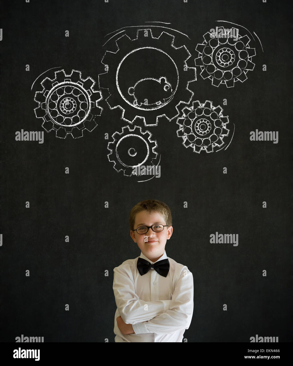 Thinking boy dressed as business man with chalk turning gear cogs and ...