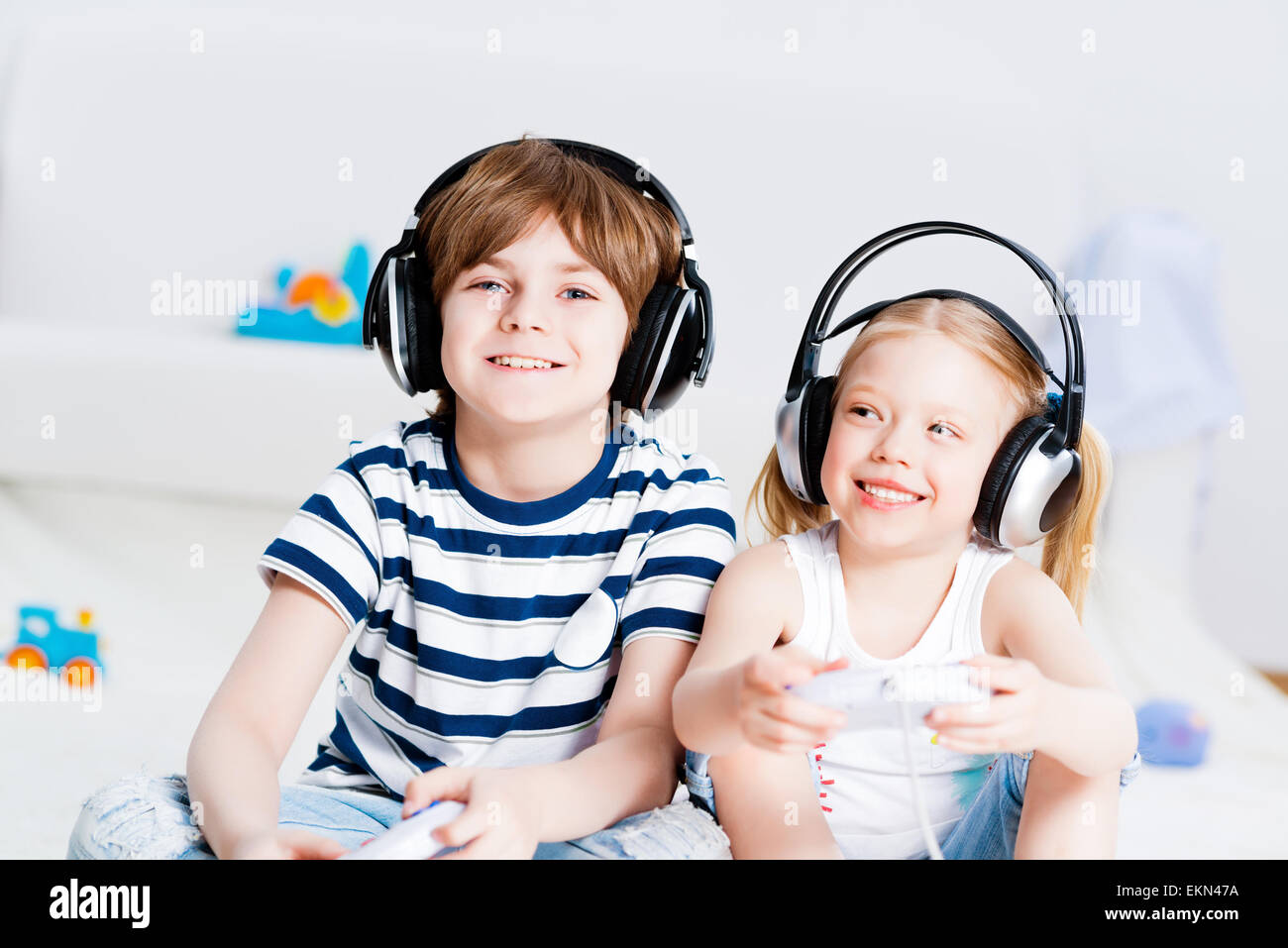 cute boy and girl playing gaming console Stock Photo - Alamy