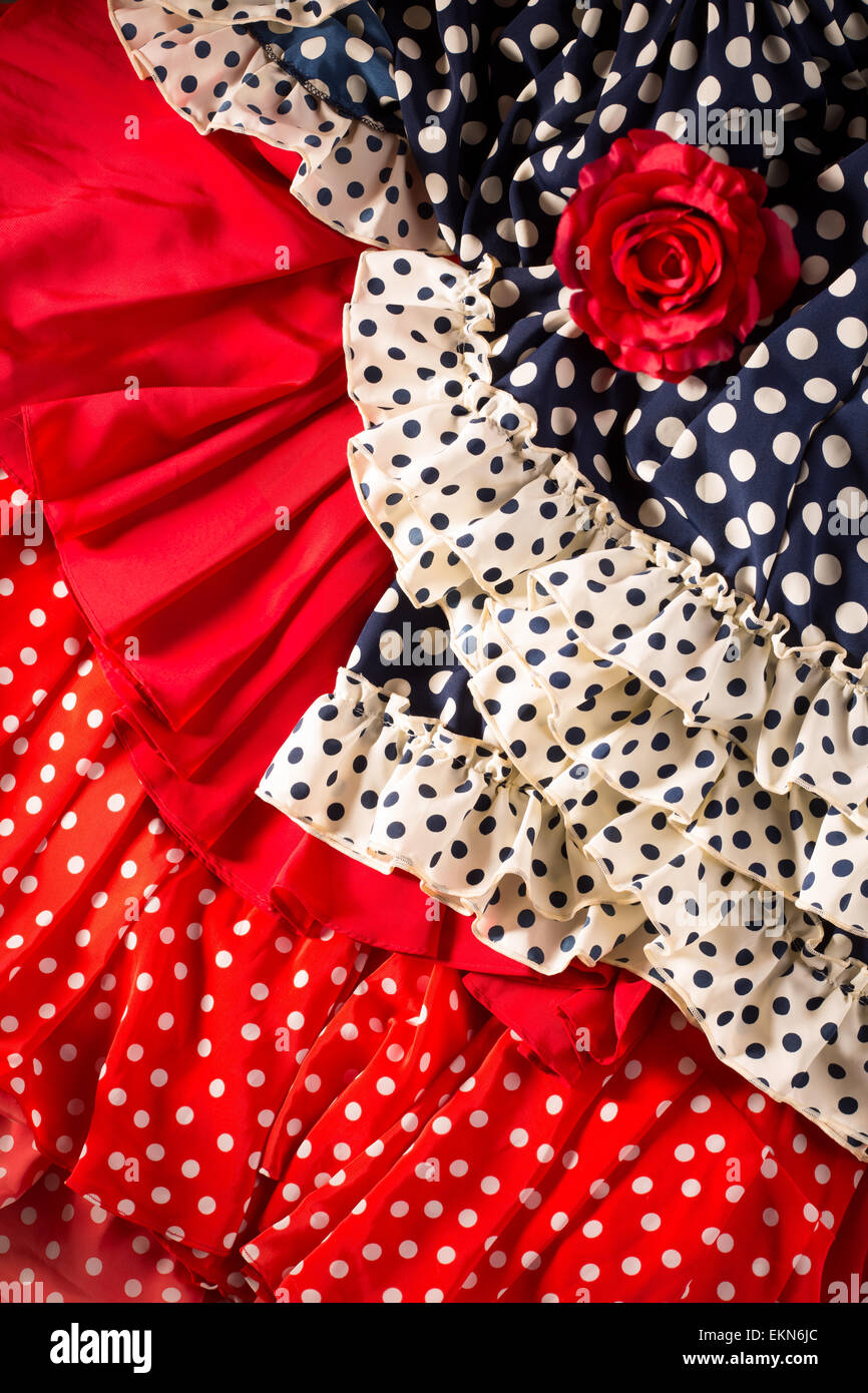 Flamenco dresses in red blue with spot and red rose Stock Photo - Alamy