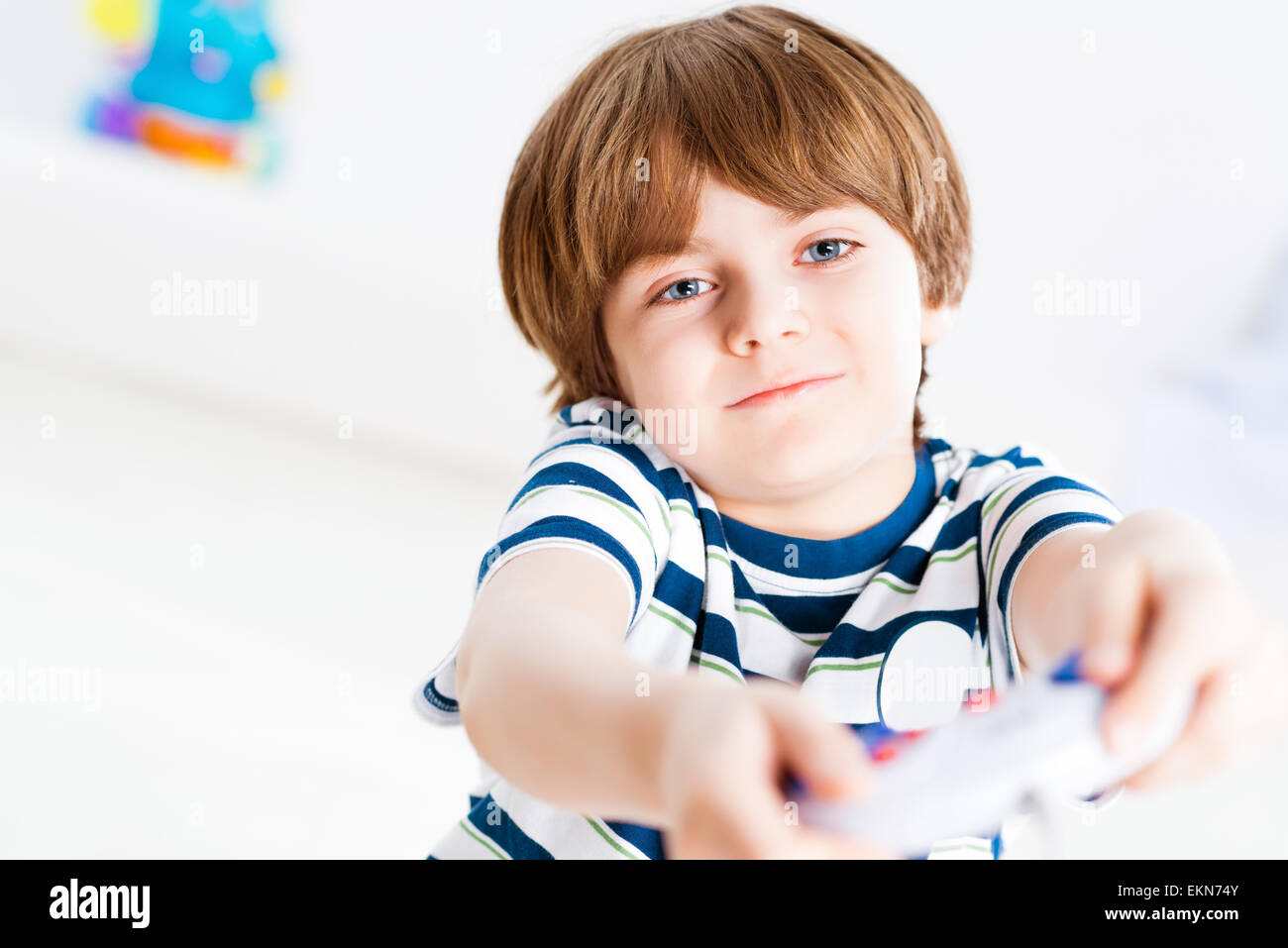 Boy playing on a game console Stock Photo - Alamy