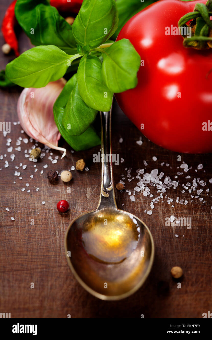 Spoon with Olive Oil and vegetables Stock Photo - Alamy