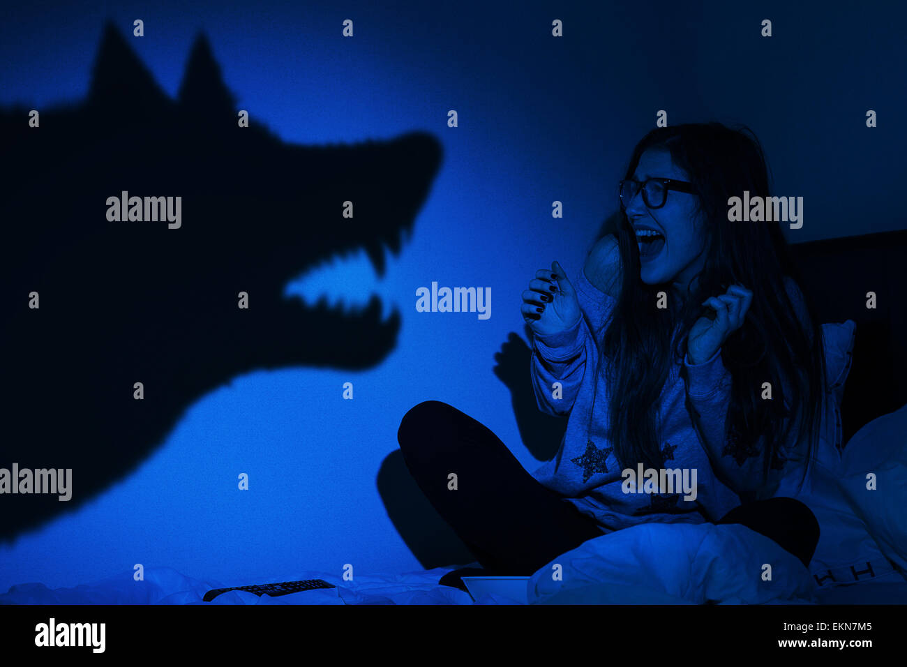 Beautiful girl frightened from wolf shadow Stock Photo - Alamy