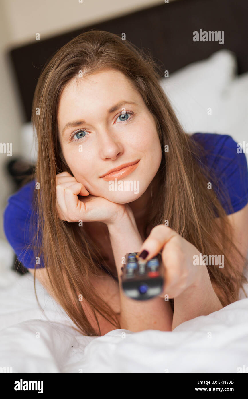 Beautiful caucasian girl with TV console Stock Photo - Alamy
