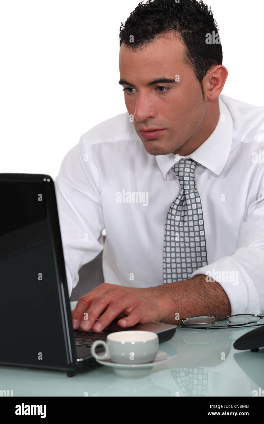 Executive working on his laptop Stock Photo - Alamy