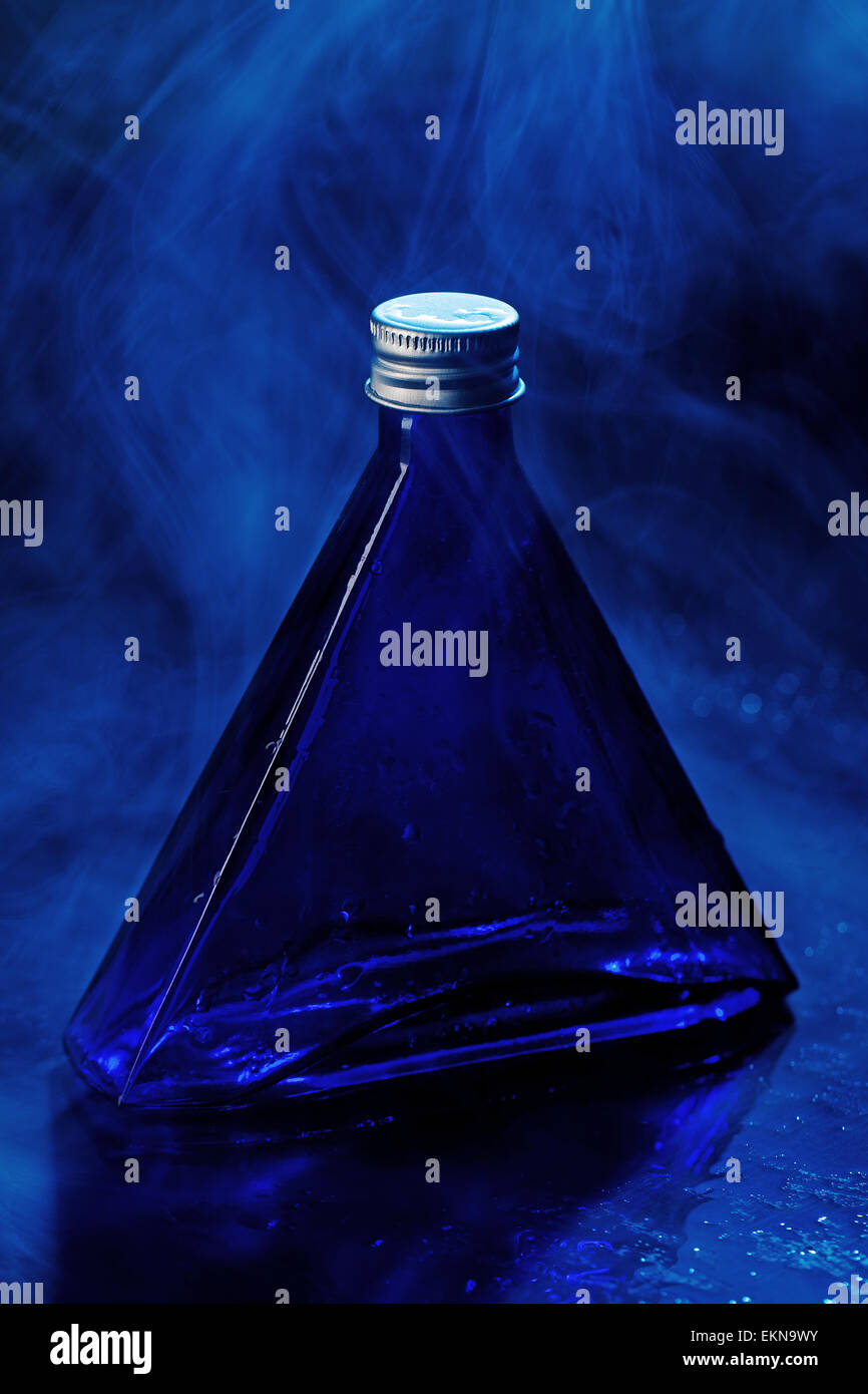 Little blue bottle on a background Stock Photo - Alamy