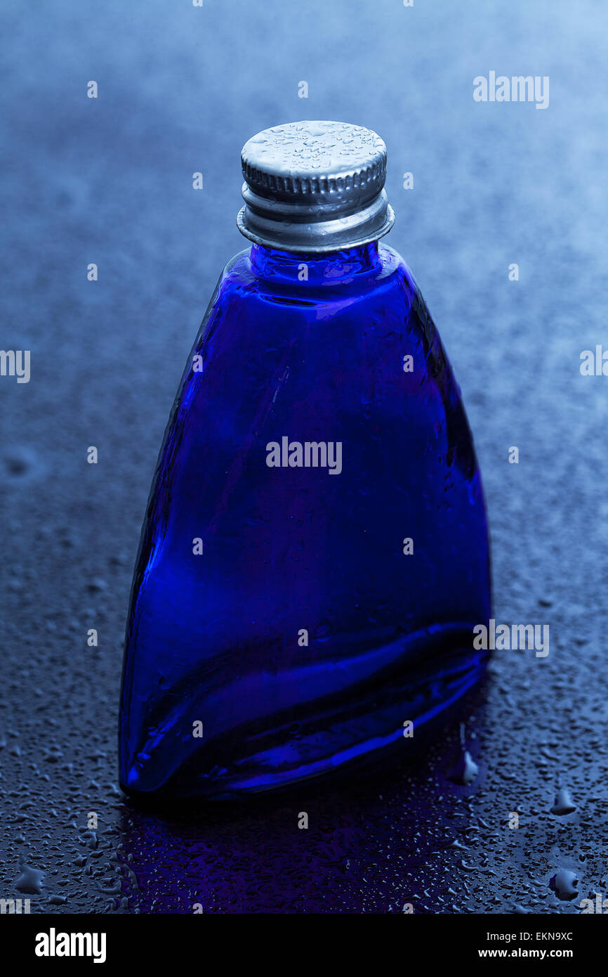 Little blue bottle on a background Stock Photo - Alamy