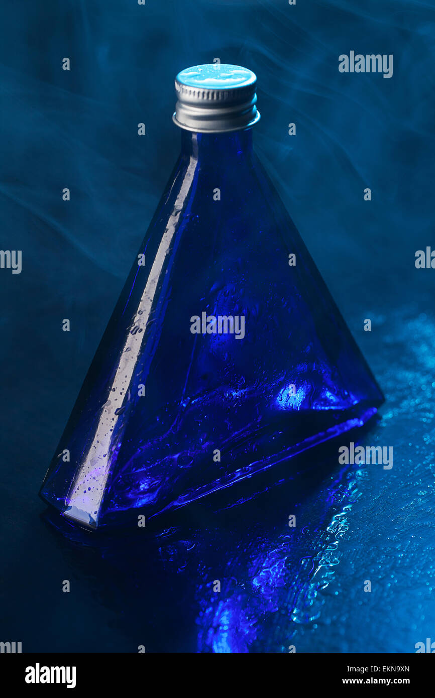 Little blue bottle on a background Stock Photo - Alamy