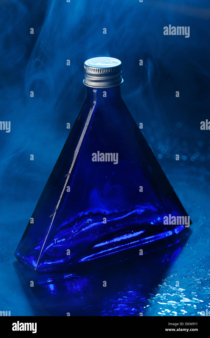 Little blue bottle on a background Stock Photo - Alamy