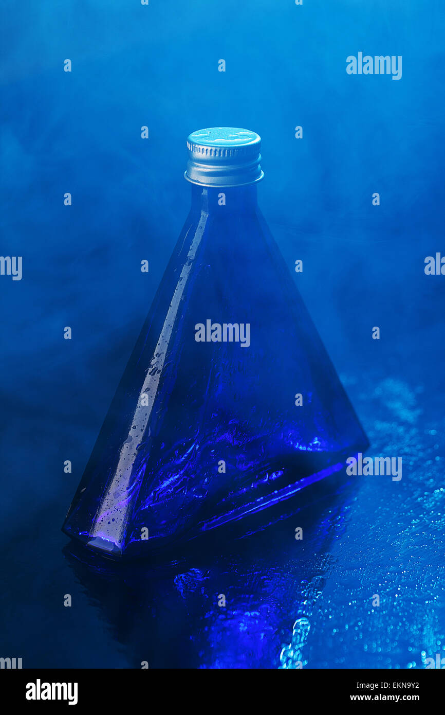 Little blue bottle on a background Stock Photo - Alamy