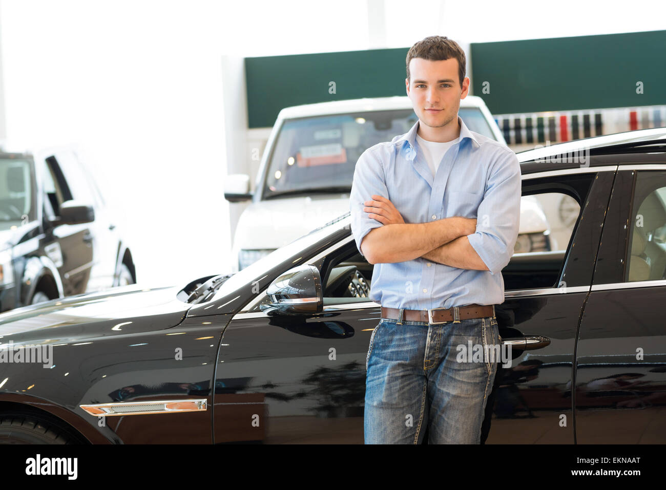 man standing near a car Stock Photo - Alamy
