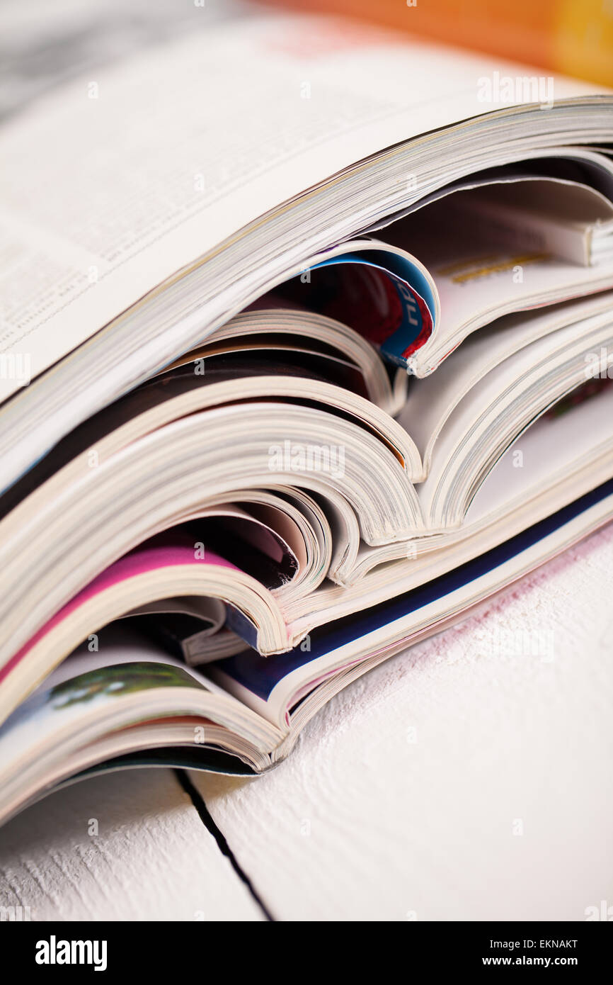 Pile of colorful magazines on a table Stock Photo - Alamy