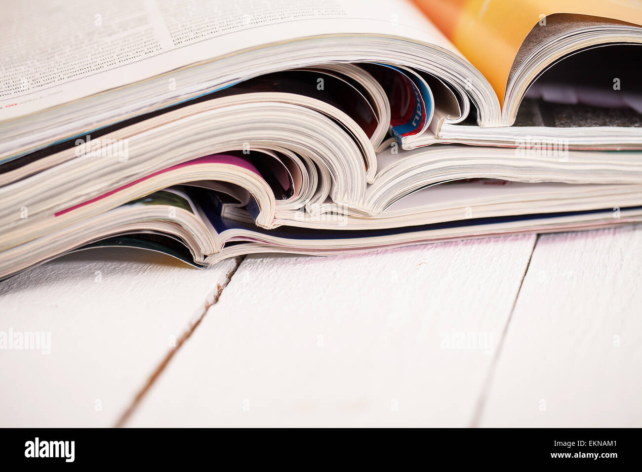 Pile of colorful magazines on a table Stock Photo - Alamy