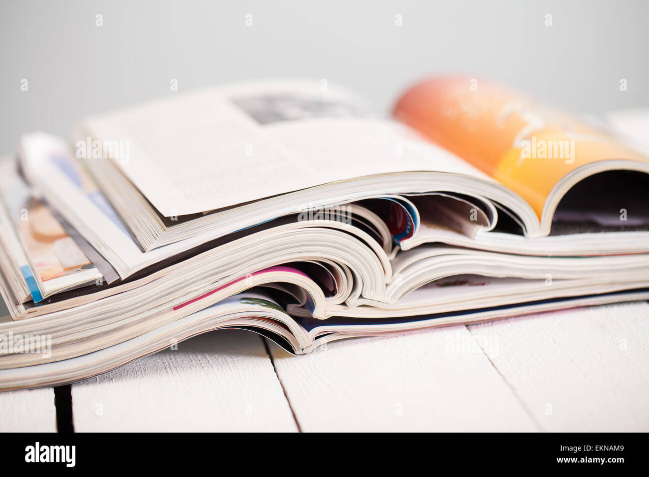 Pile of colorful magazines on a table Stock Photo - Alamy