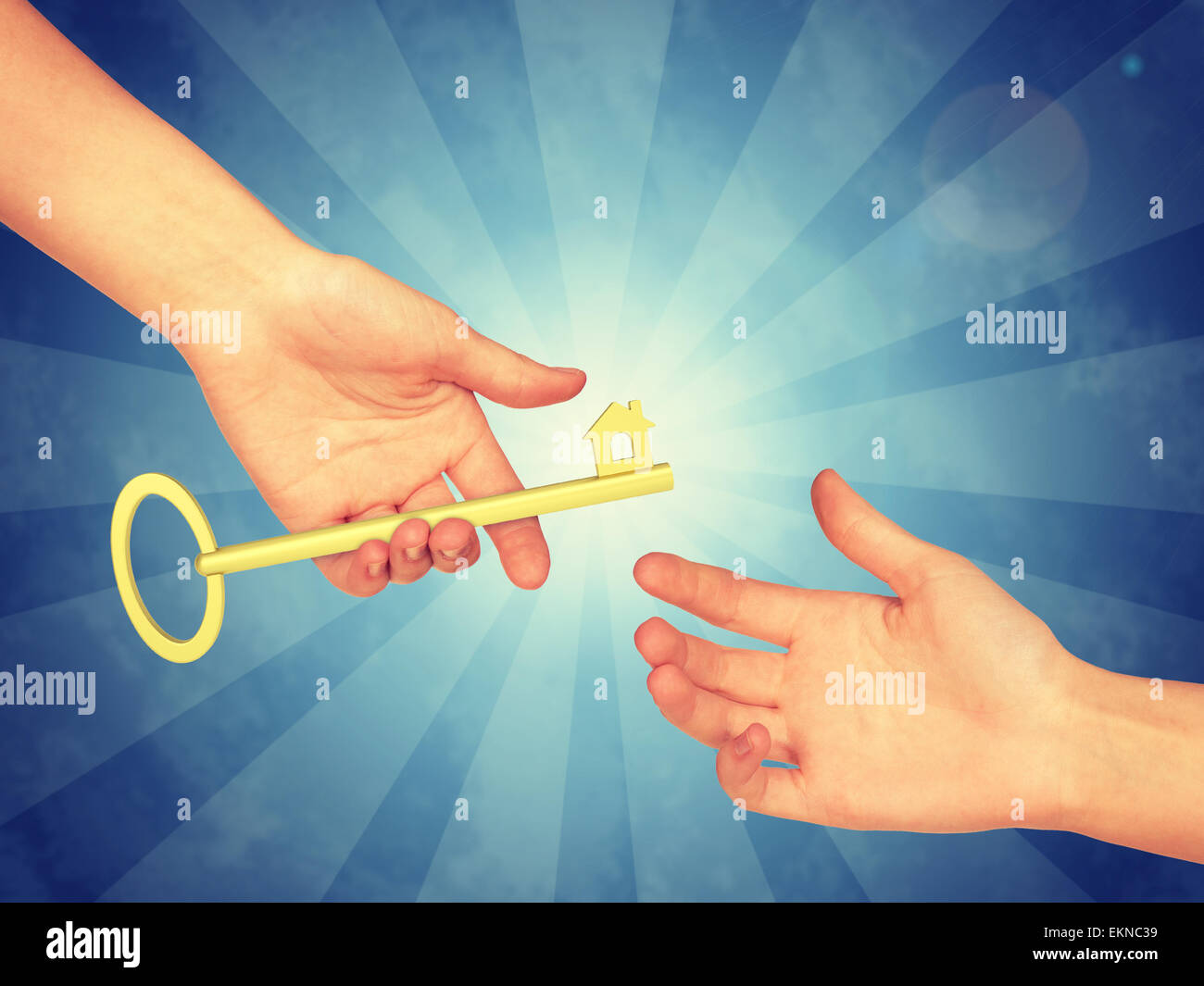 Hand passing a gold key Stock Photo - Alamy