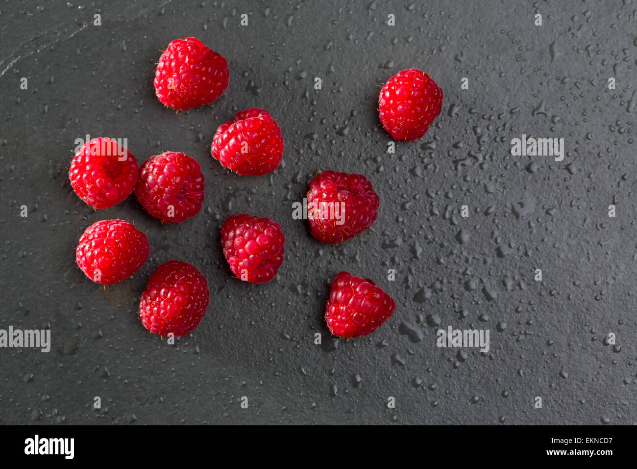 berries raspberry on black slate background Stock Photo - Alamy