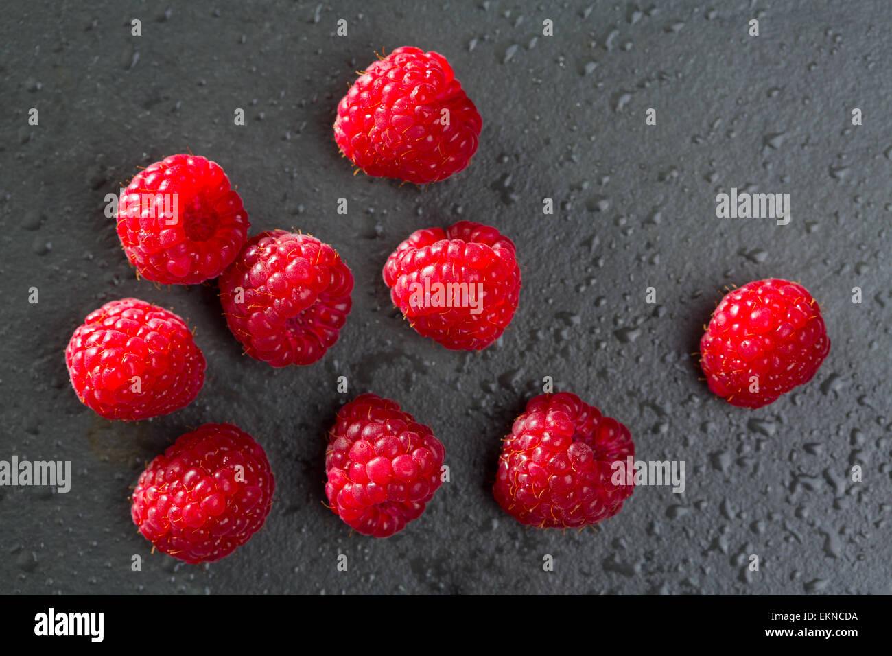 berries raspberry on black slate background Stock Photo - Alamy