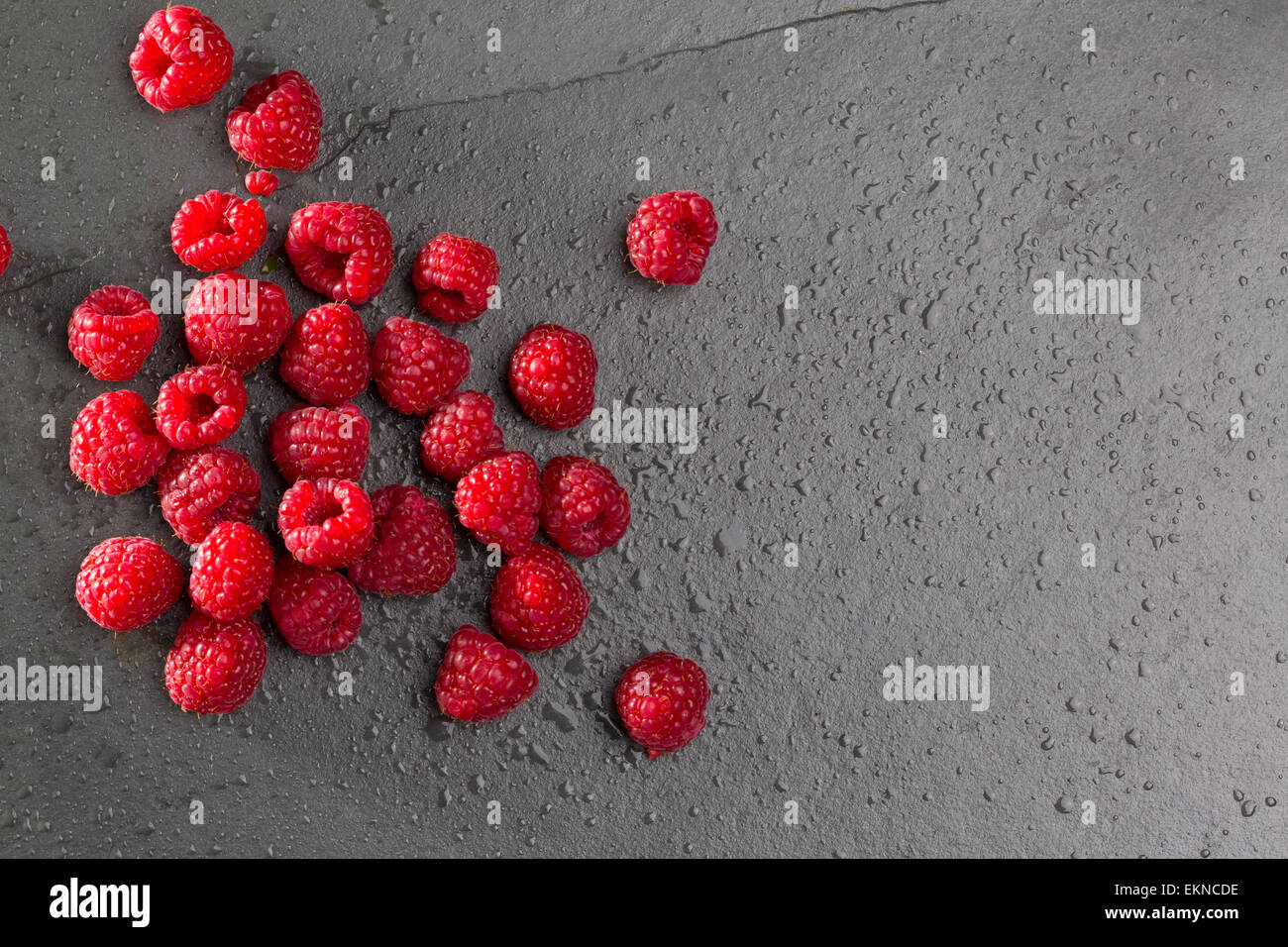 berries raspberry on black slate background Stock Photo - Alamy