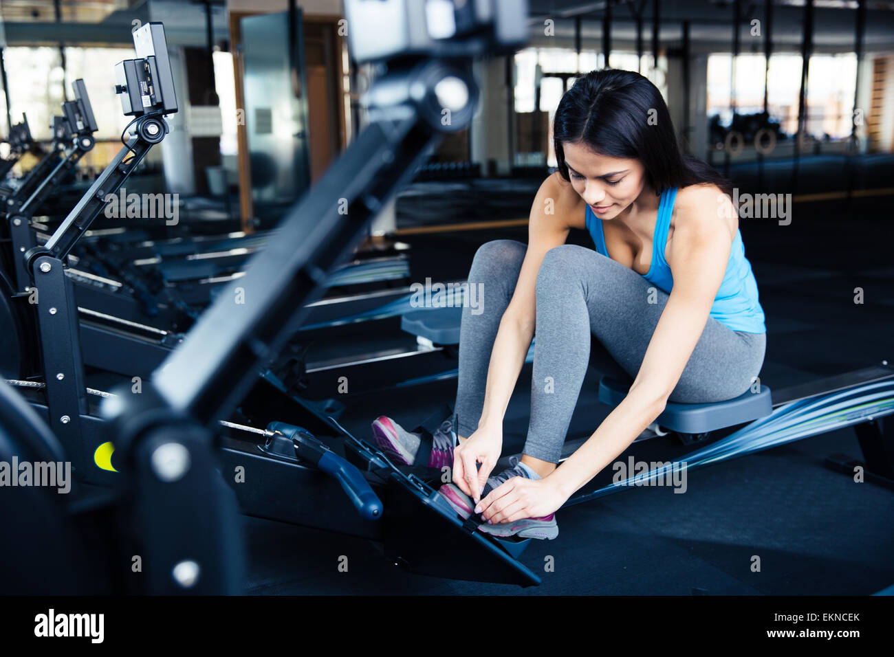 Young woman preparing to exercise on a simulator at gym Stock Photo - Alamy