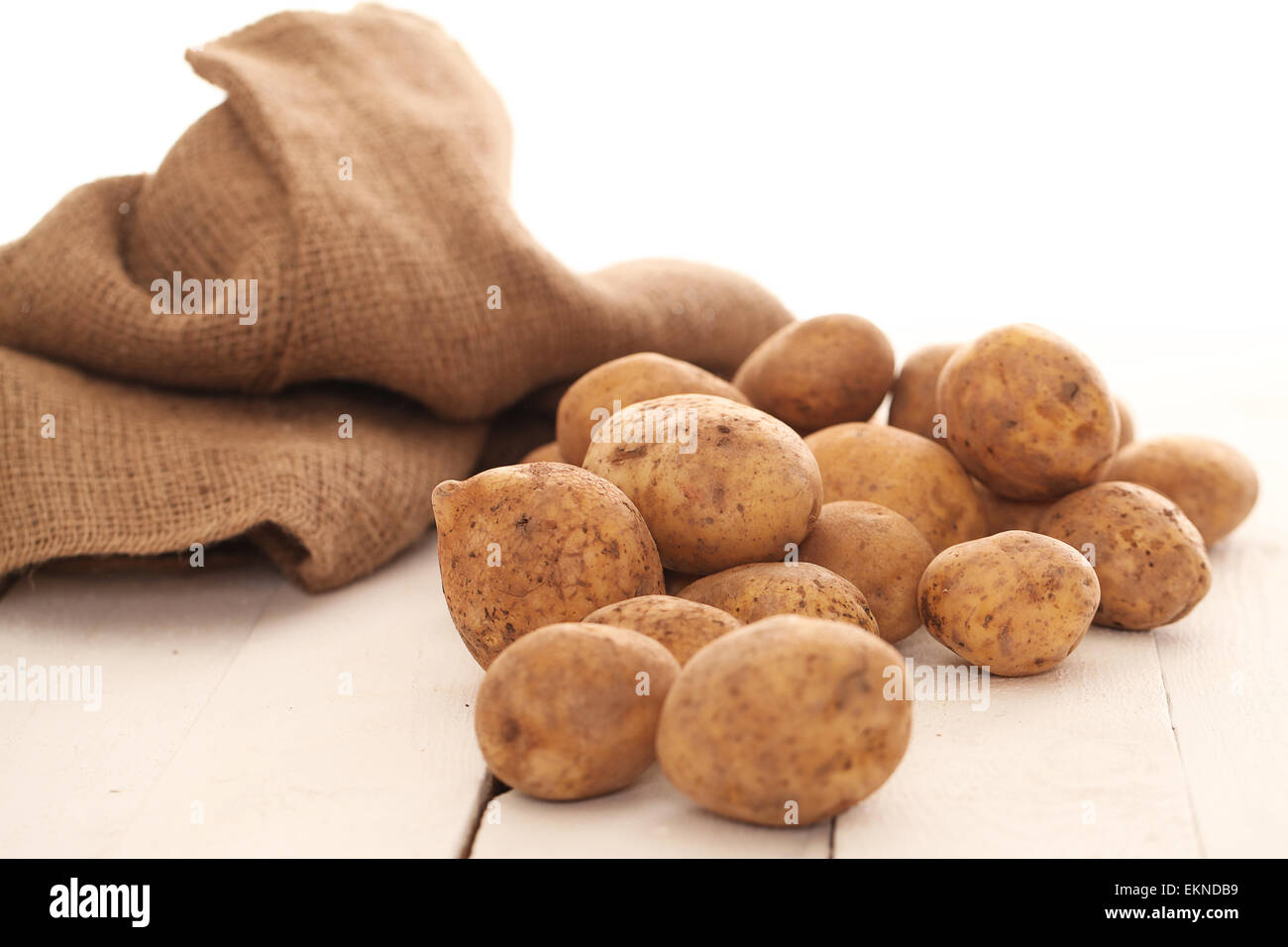 Rustic unpeeled potatoes on a table Stock Photo - Alamy