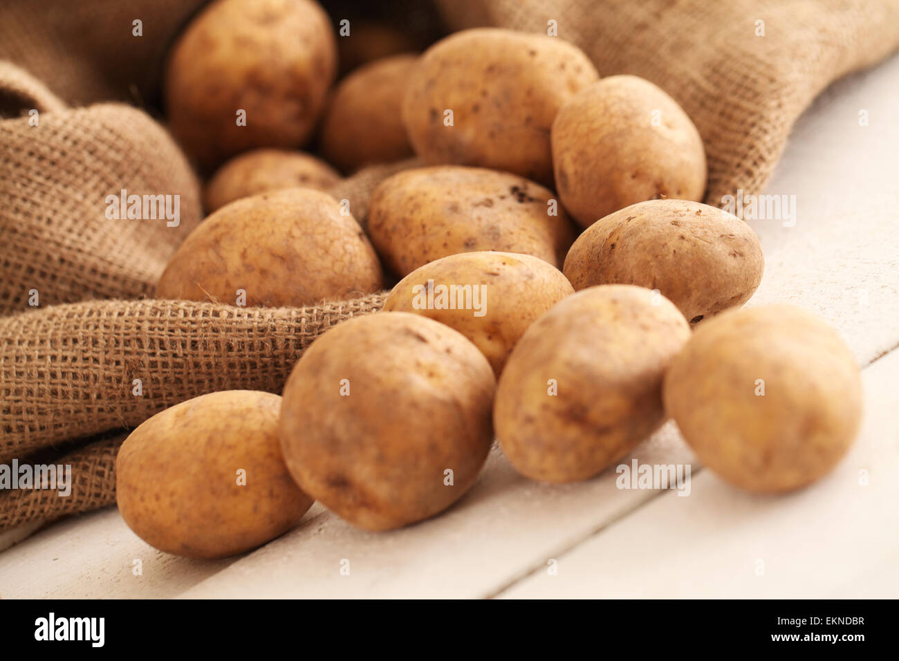 Rustic unpeeled potatoes on a table Stock Photo - Alamy