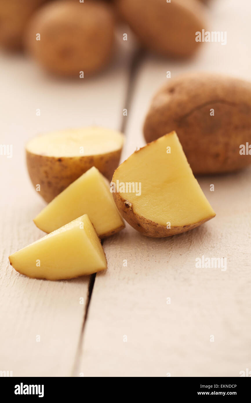 Rustic unpeeled potatoes on a table Stock Photo - Alamy