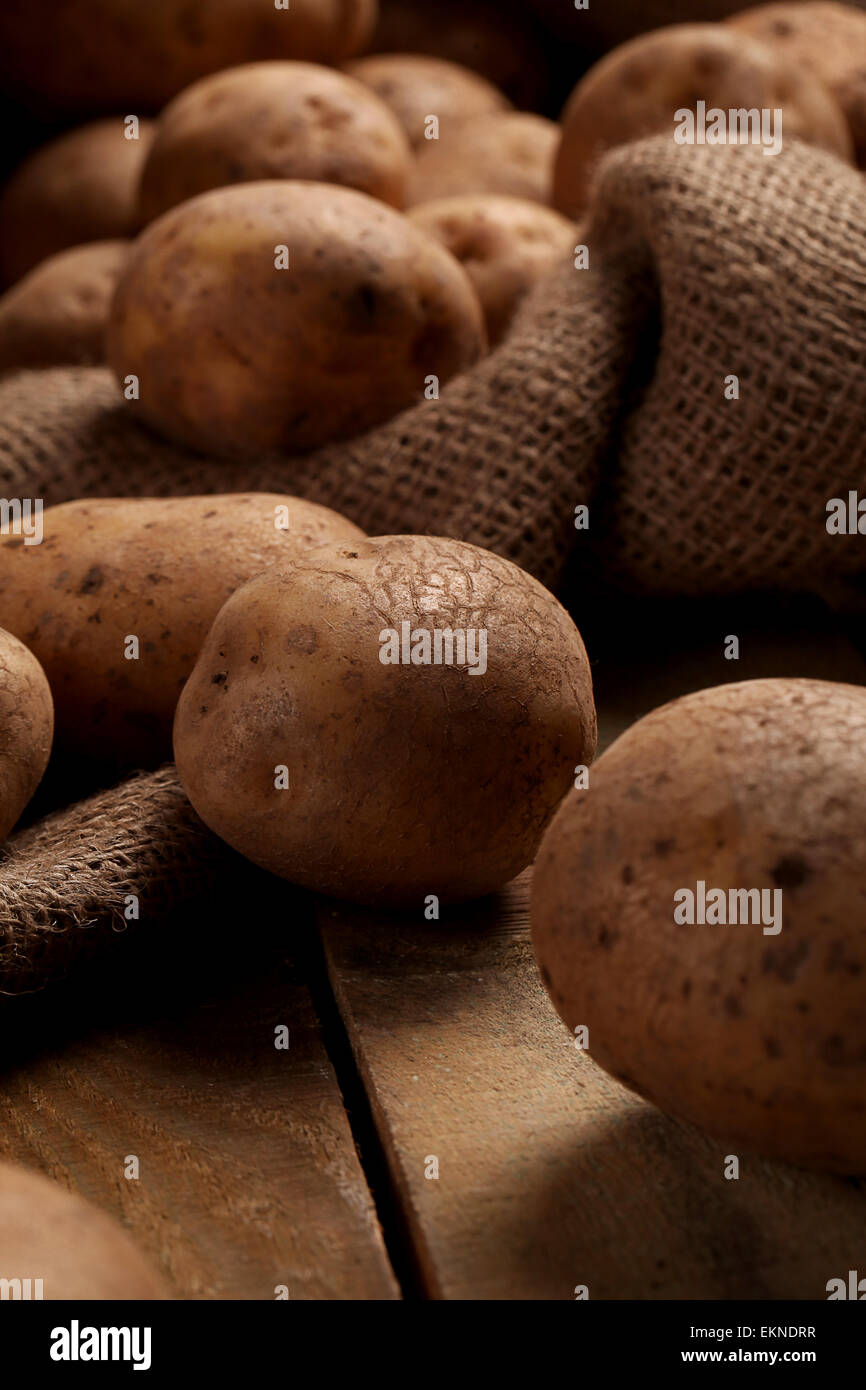 Rustic unpeeled potatoes on a desks Stock Photo - Alamy