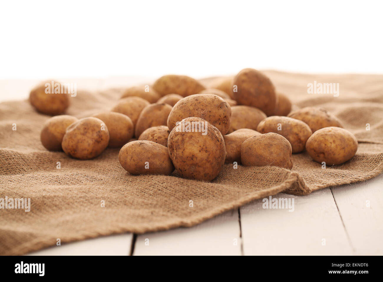 Rustic unpeeled potatoes on a table Stock Photo - Alamy