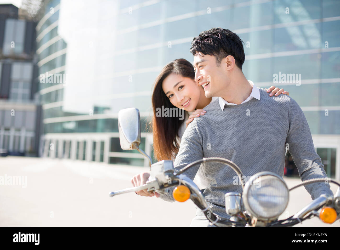 Young couple riding motorcycle together Stock Photo - Alamy