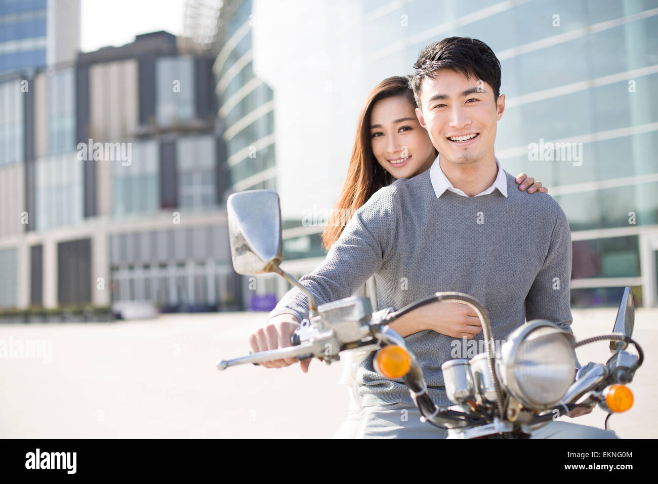 Young couple riding motorcycle together Stock Photo - Alamy