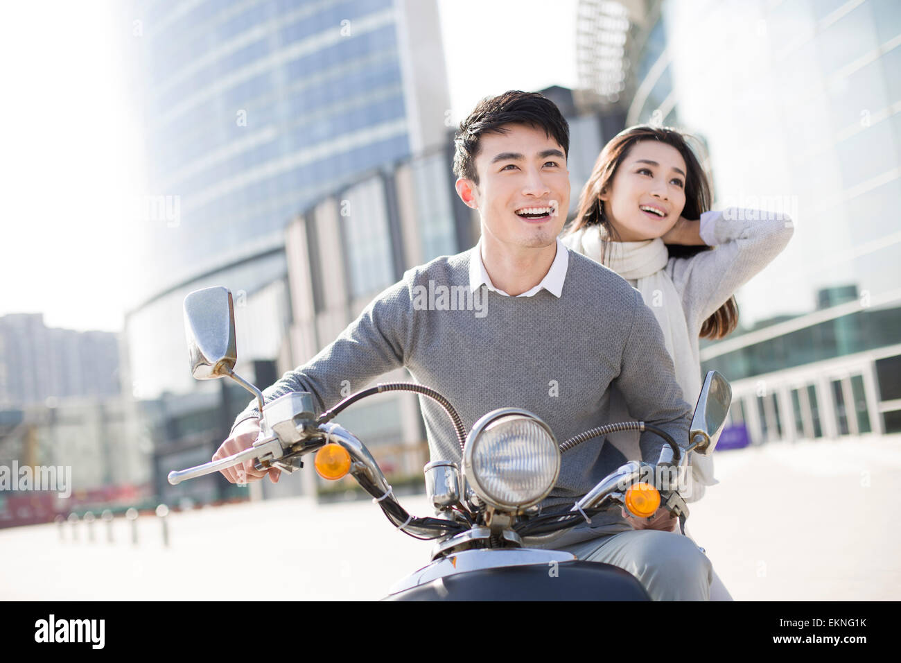 Young couple riding motorcycle together Stock Photo - Alamy
