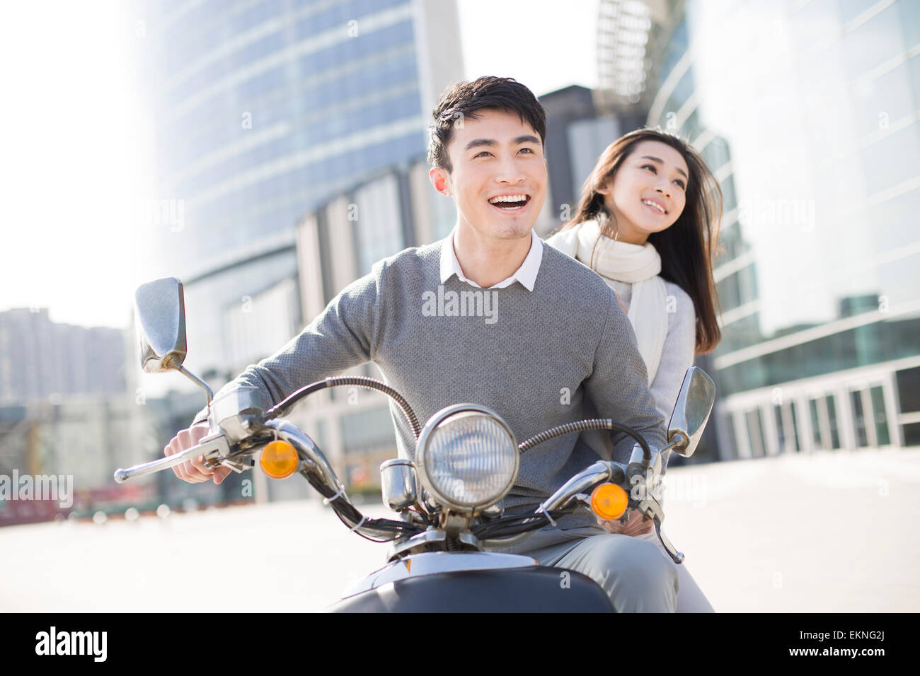Young couple riding motorcycle together Stock Photo - Alamy