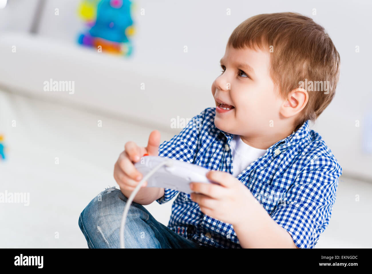Boy playing on a game console Stock Photo - Alamy