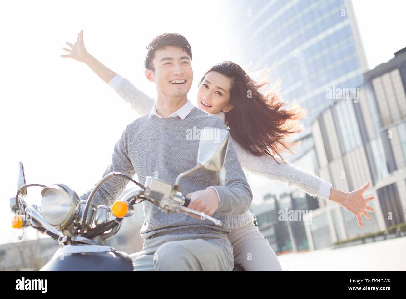 Young couple riding motorcycle together Stock Photo - Alamy