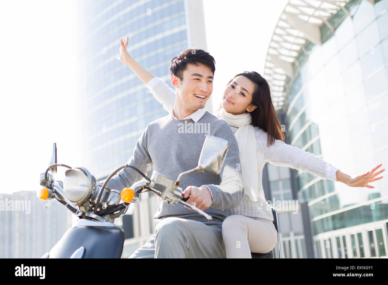 Young couple riding motorcycle together Stock Photo - Alamy