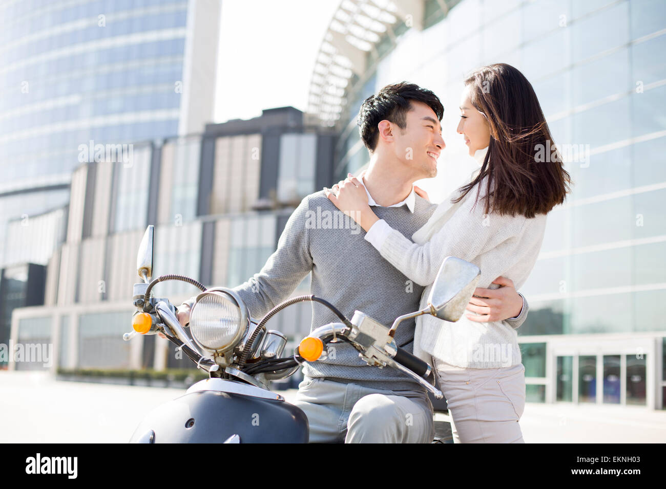 Young couple riding motorcycle together Stock Photo - Alamy