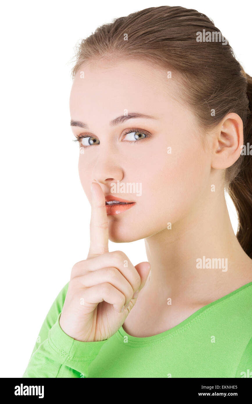 Hush be quiet woman isolated. Teen girl with finger on her lips Stock ...