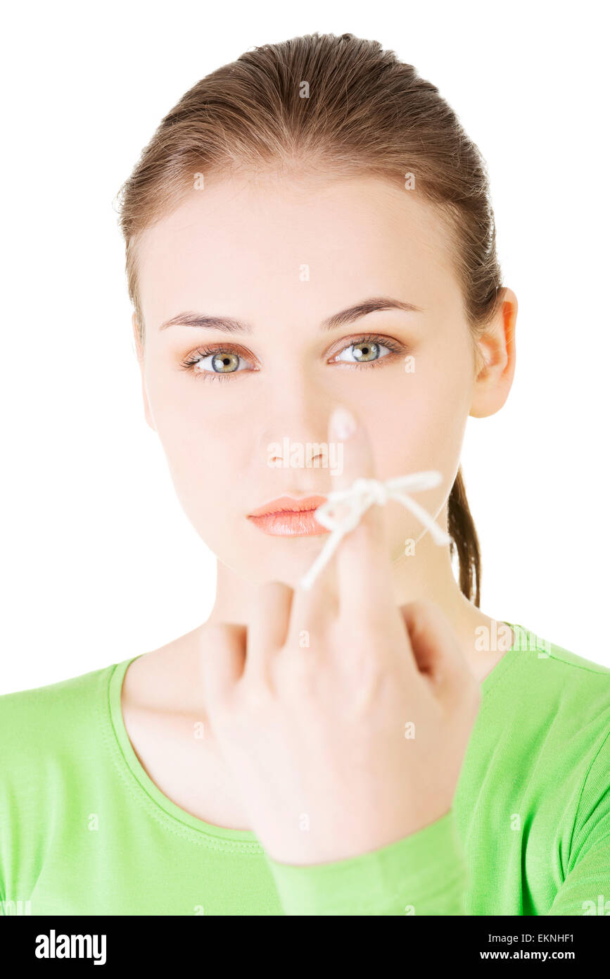 Woman trying to remember with the piece of string round her fing Stock ...