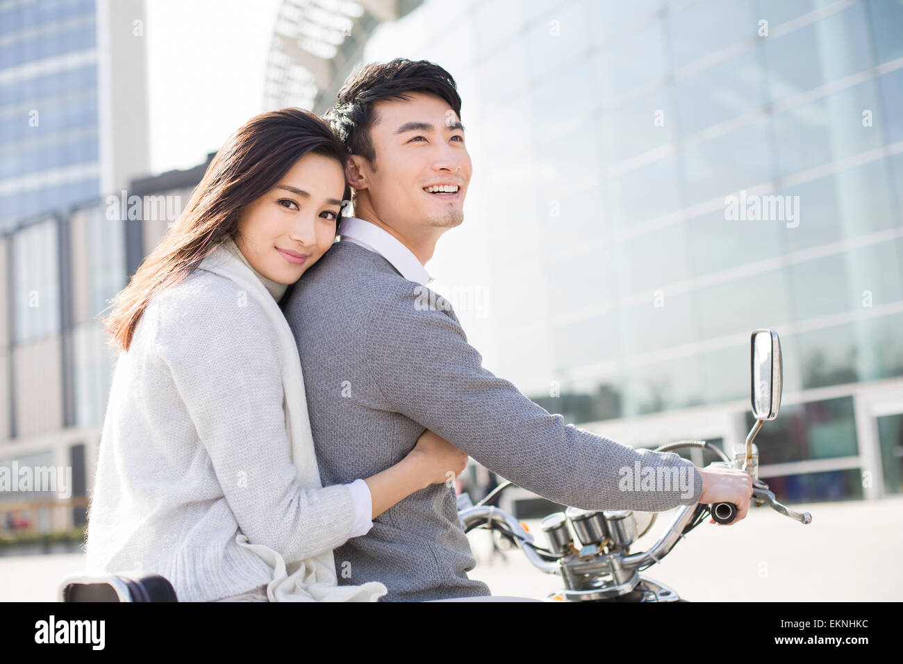 Young couple riding motorcycle together Stock Photo - Alamy