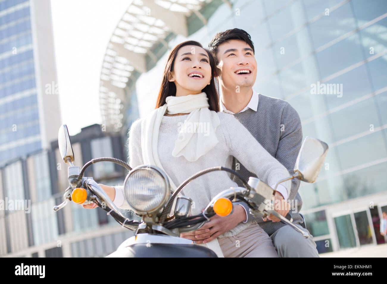 Young couple riding motorcycle together Stock Photo - Alamy
