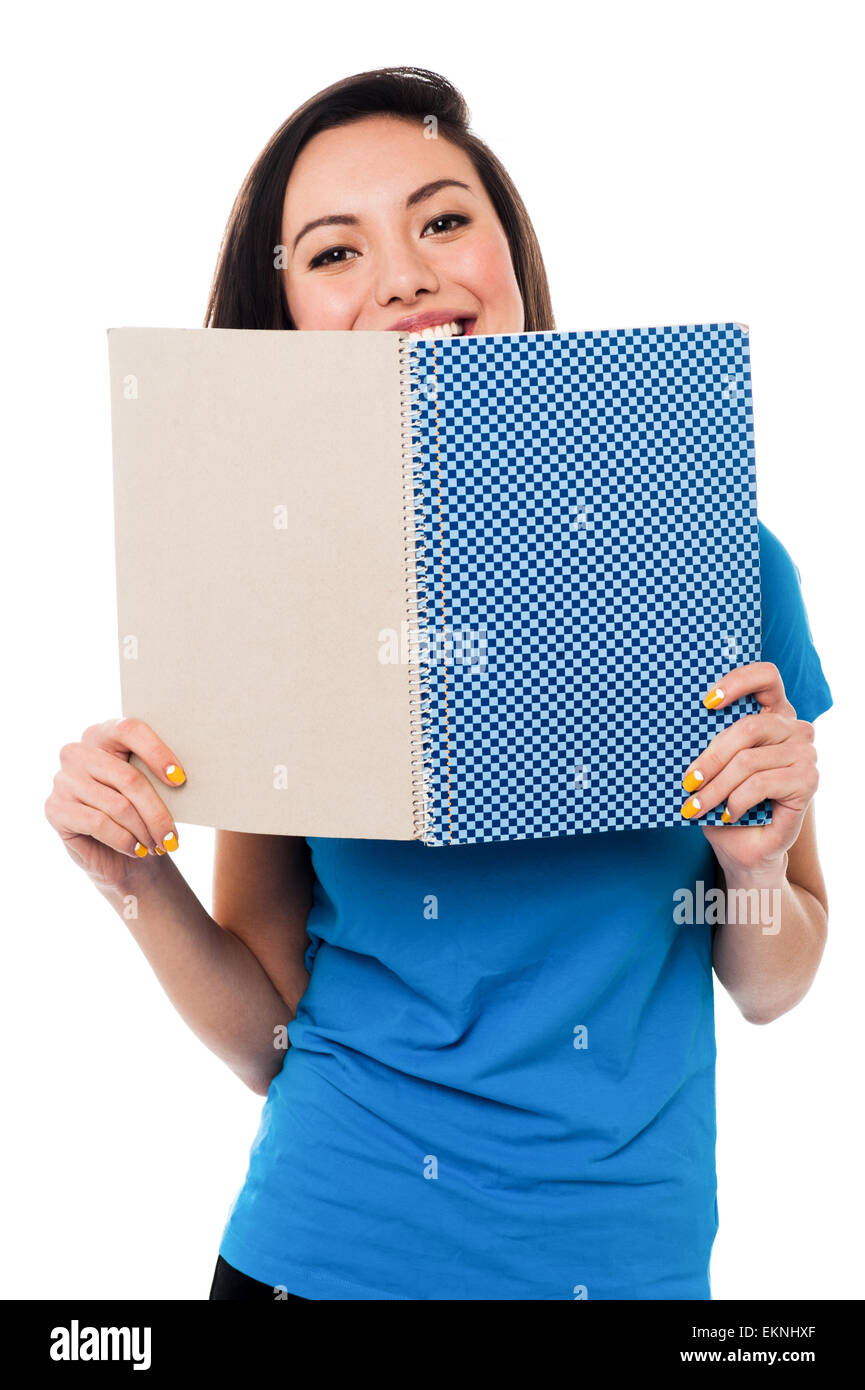 Young girl hiding her face with notebook Stock Photo - Alamy