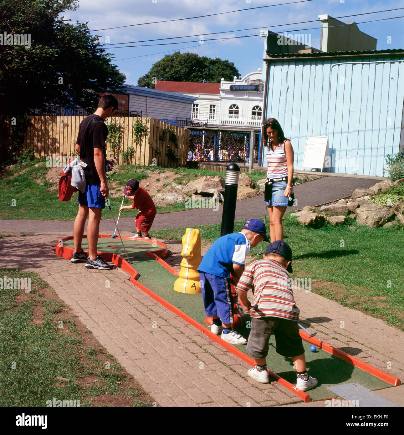 A family with 3 little boys aged 4 playing miniature golf at Oakwood ...