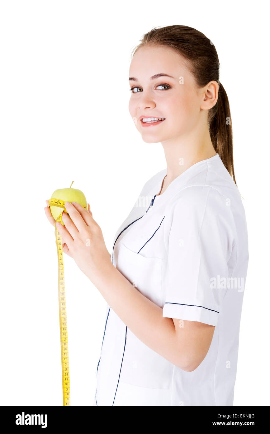 Smiling woman doctor with a green apple and measuring tape Stock Photo ...