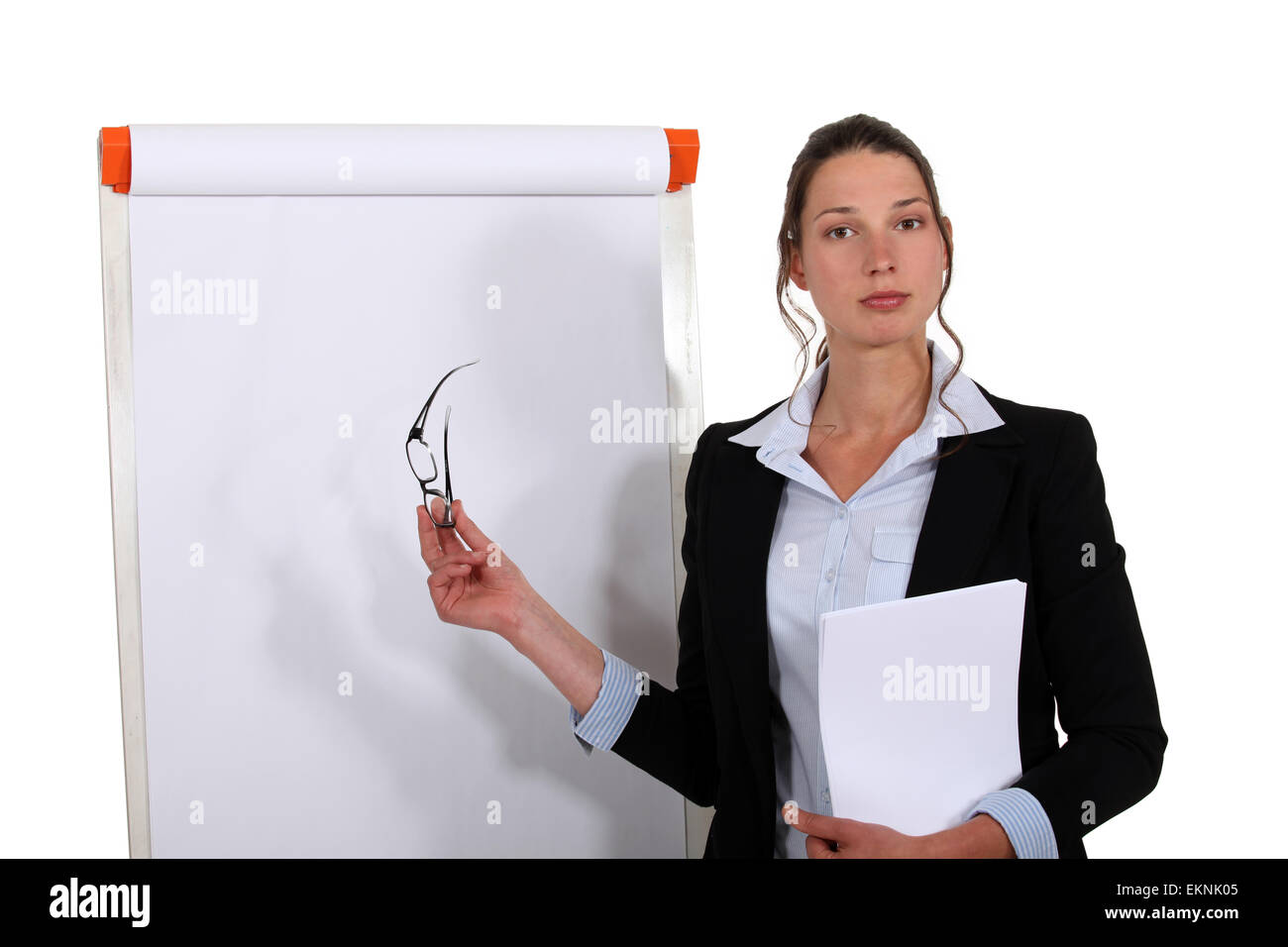 Businesswoman stood by flip chart Stock Photo - Alamy