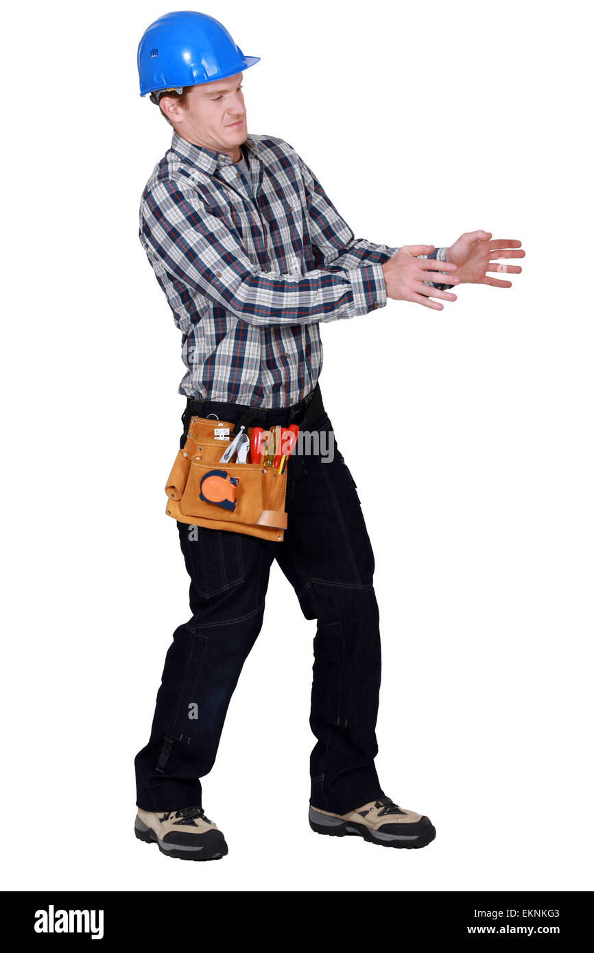 Laborer gesturing on white background Stock Photo - Alamy