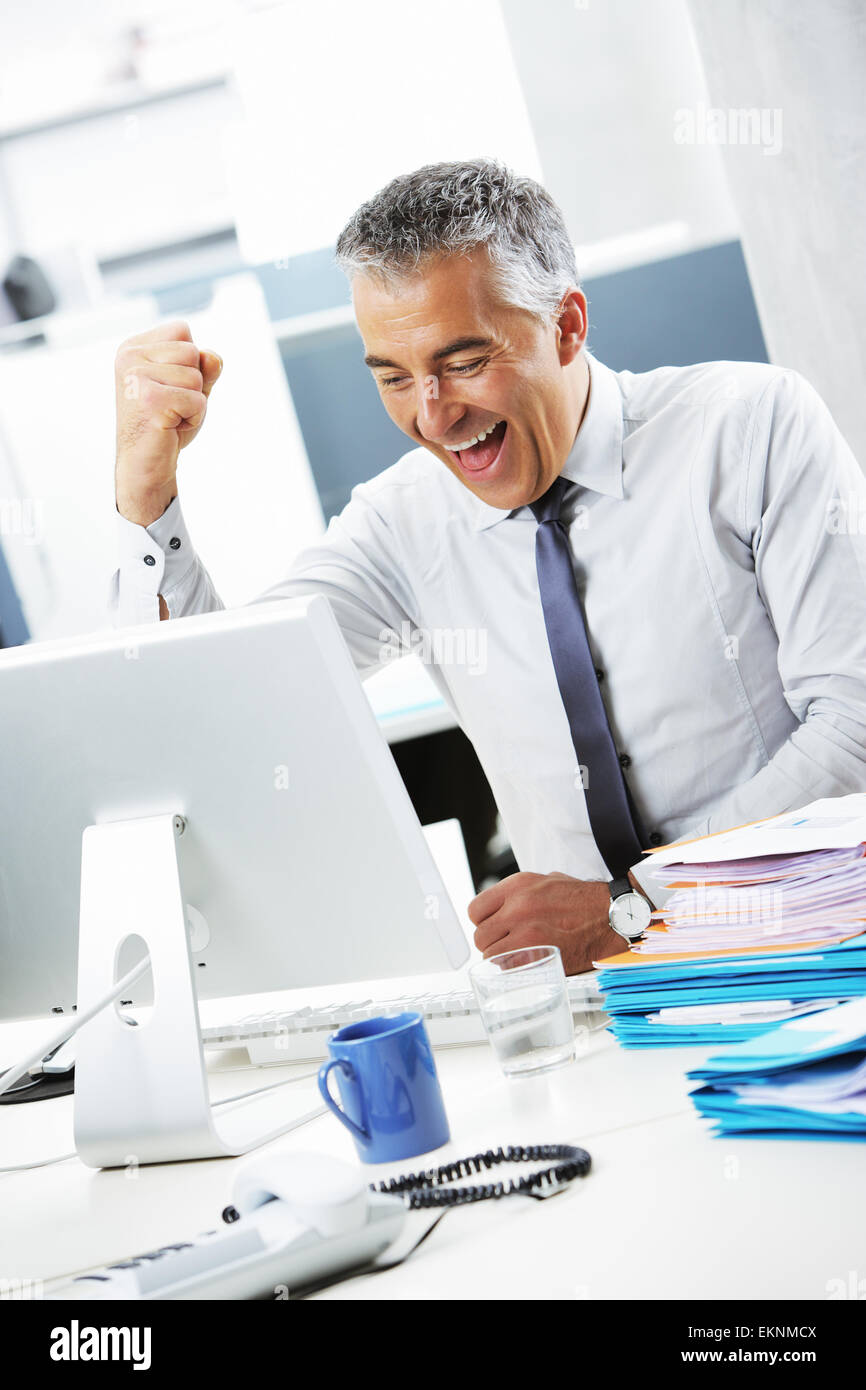 Man celebrating success on documents hi-res stock photography and ...