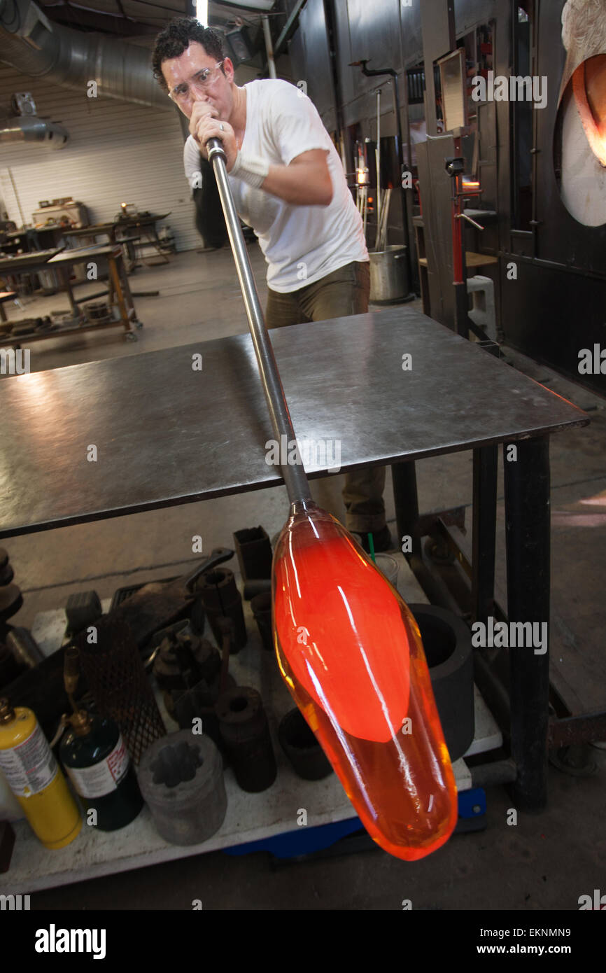 Man Blowing into Glass Object Stock Photo - Alamy