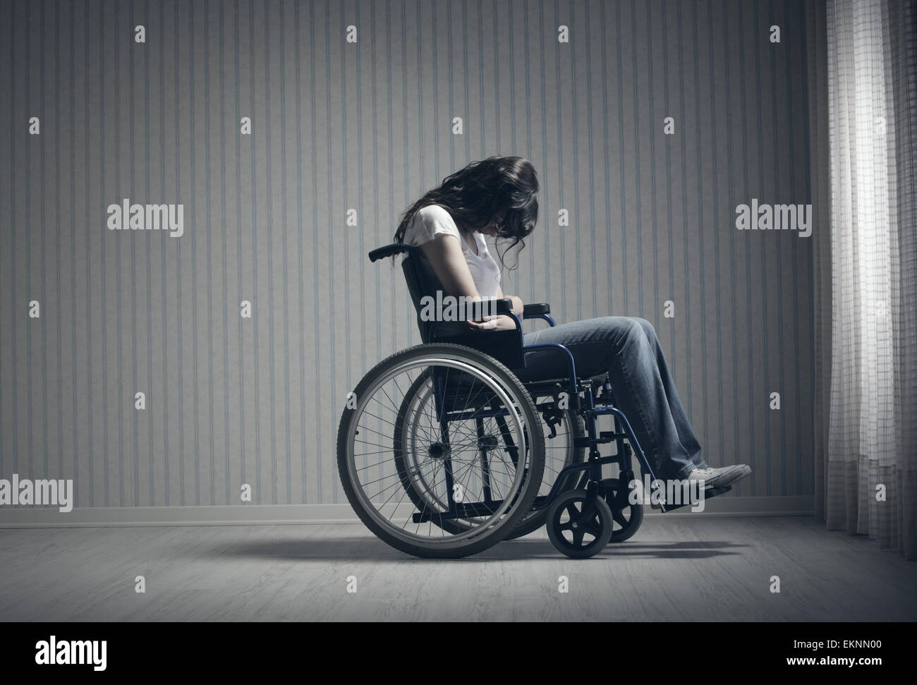 Crying woman sitting in wheelchair Stock Photo - Alamy