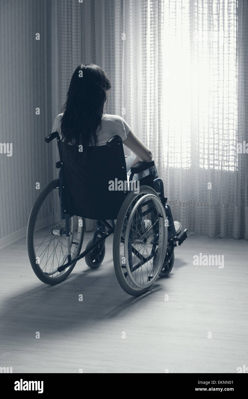 Sad woman sitting on wheelchair Stock Photo - Alamy