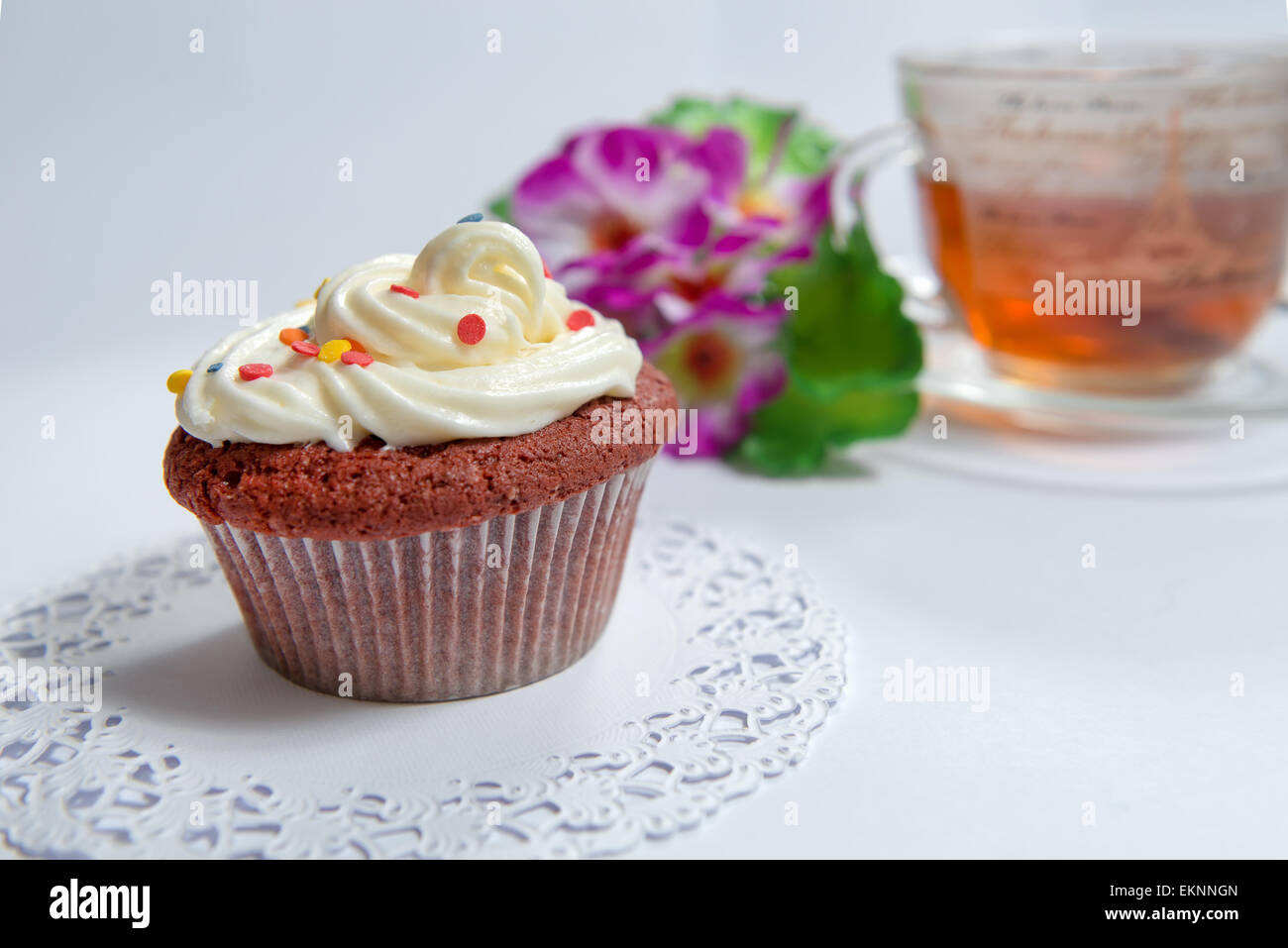 Sweet cake with cup of tea and flowers Stock Photo - Alamy