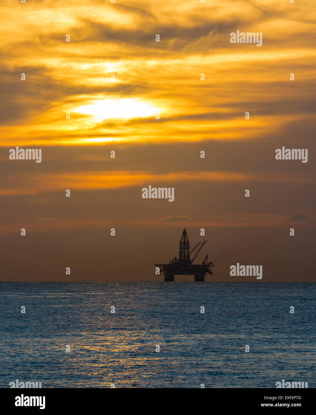 Oil rig at sunrise Stock Photo - Alamy